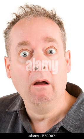 Frightened shocked man afraid of something and looks into camera with ...