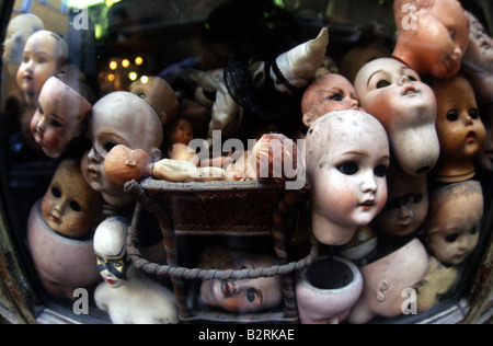 array of disembodied doll heads in shop window Stock Photo - Alamy