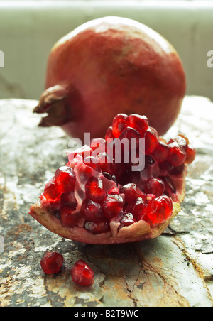 Pomegranate Seeds and Pomegranates on a Stone Gray Background Close-up ...
