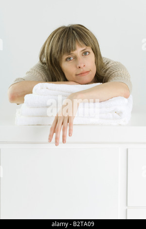Woman leans on counter while looking at camera in her kitchen Stock ...