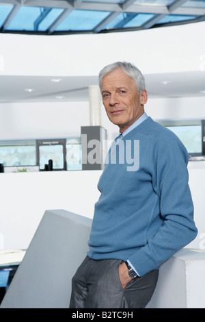 Man leaning against balustrade Stock Photo - Alamy