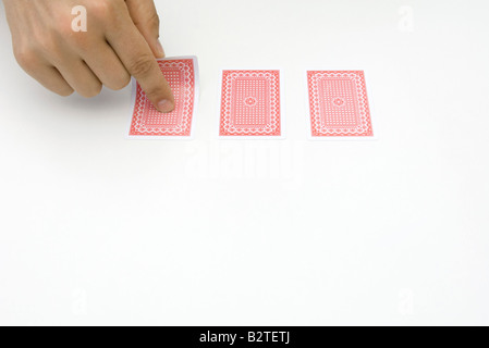 Hands turning over a playing card Stock Photo - Alamy
