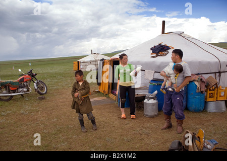 Mongolia - nomad children in front of a traditional ger in the stepps ...