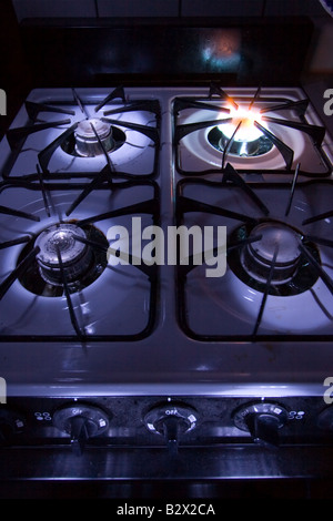 Gas pilot light on stove top with blue flame Stock Photo - Alamy