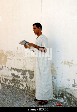 Young man stands reading newspaper in new shopping centre, Voronezh ...