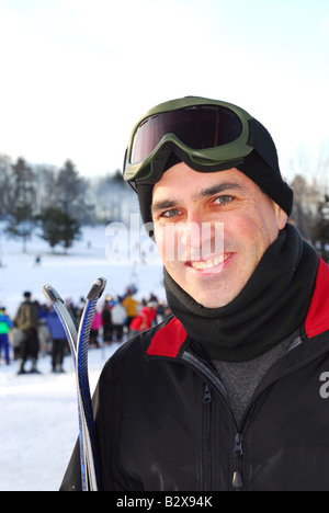 Young handsome skier man skiing wearing snow sportswear using ski ...