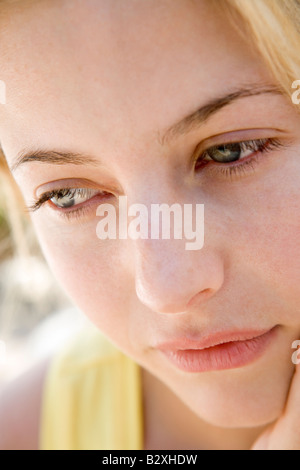 Portrait of young female sad and thinking on sofa indoors Stock Photo ...
