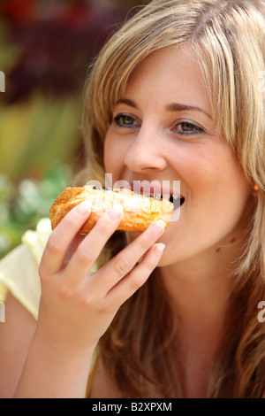 Young Woman Eating Cinnamon Raisin Bun Model Released Stock Photo - Alamy
