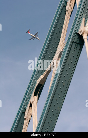 An airplane flying over the Tower Bridge of London,UK. Airplane low ...