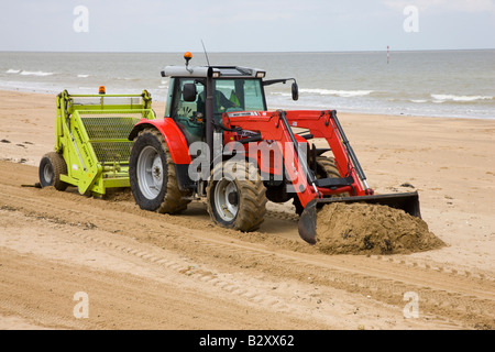 Tractor raking and shovelling the sand on the beach in Margate Kent ...