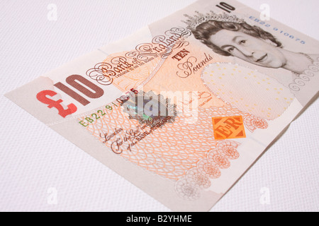 10 ten pound sterling english money bank note on the pavement next to a ...