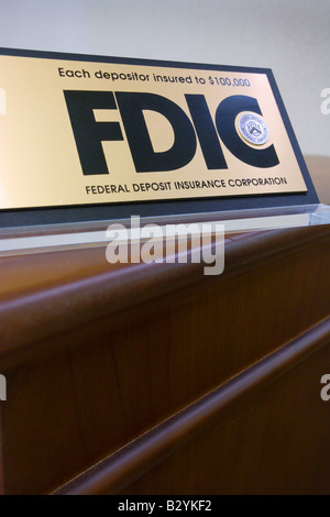 FDIC plaque resting on a bank counter top Stock Photo - Alamy