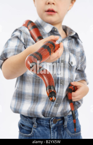 Boy holding pet snake Stock Photo - Alamy