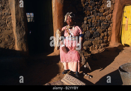 Sangoma (traditional healer) sitting in front of house, Lesotho, Africa Stock Photo - Alamy
