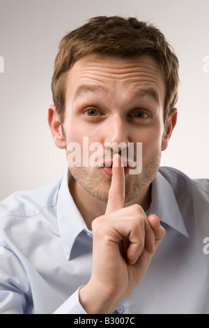 man shushing with hand gesture Stock Photo - Alamy