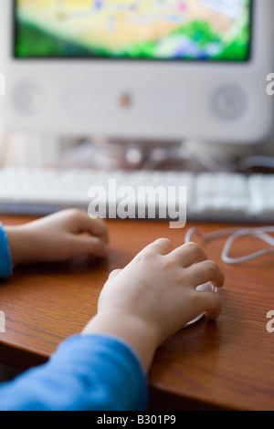 Hand using computer mouse connected to globe Stock Photo - Alamy