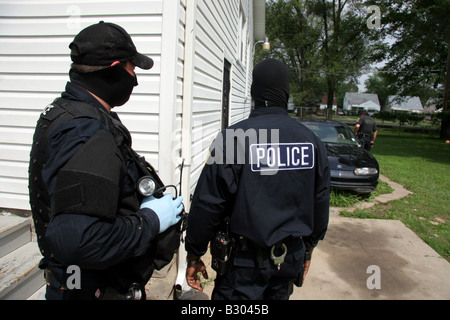 Police officers from the Detroit Narcs approach a house suspected of ...