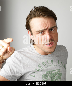 Angry and mean looking man pointing with finger Stock Photo - Alamy