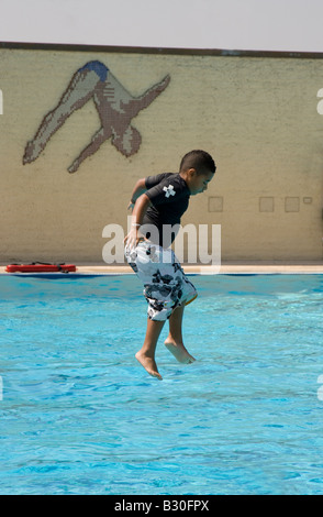 boy jumping into a swimming pool Stock Photo - Alamy