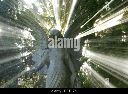 standing angel sculpture surrounded by a dazzling aura of light Stock ...