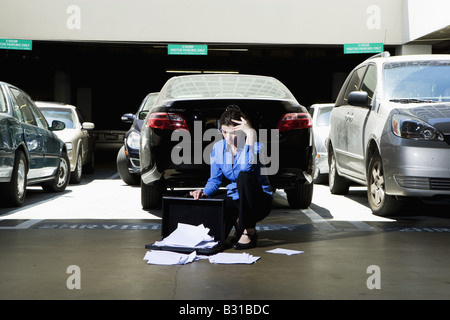 Woman picking up dropped paper Stock Photo - Alamy