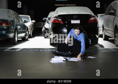 Woman picking up dropped paper Stock Photo - Alamy
