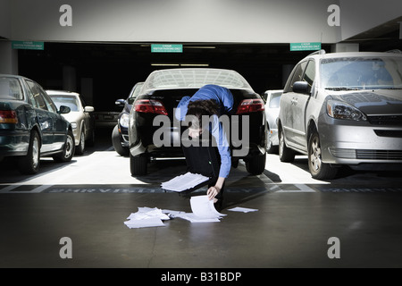 Woman picking up dropped paper Stock Photo - Alamy