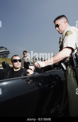 Man in Mustang handing police officer drivers license Stock Photo - Alamy