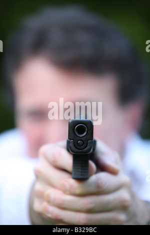 hitman gun shoot aim youth assasin asassin aim Stock Photo - Alamy