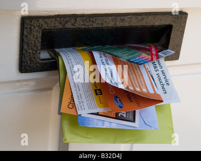 Junk mail in a letterbox Stock Photo - Alamy