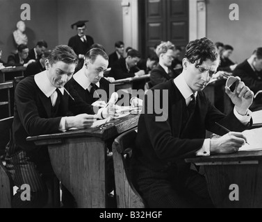 College student, man and copying test in classroom with reading ...