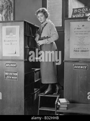 Attractive female librarian at work Stock Photo - Alamy
