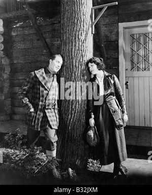 Sharing a loving glance. Smiling young man with his arm around his ...