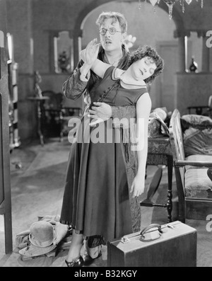 Young Caucasian woman standing with faint smile, hand on hip and other ...