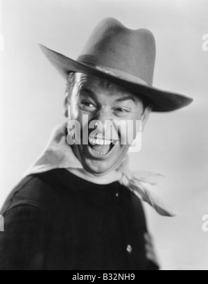 Excited young man in cowboy style outfit having fun, posing isolated ...