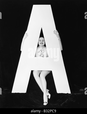 Woman with huge letter L Stock Photo - Alamy