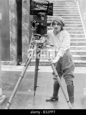 Focused Young Caucasian Female Cinematographer With Blue Hair Adjusts ...