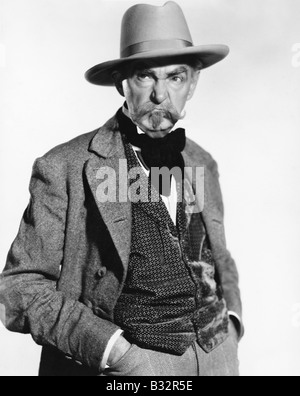 Grumpy guy in bow-tie and suspenders accusing you, its your fault ...