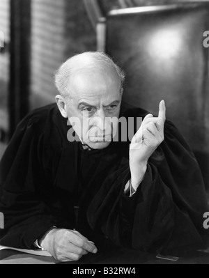 Serious, stern judge pointing his finger at the camera. Isolated on ...