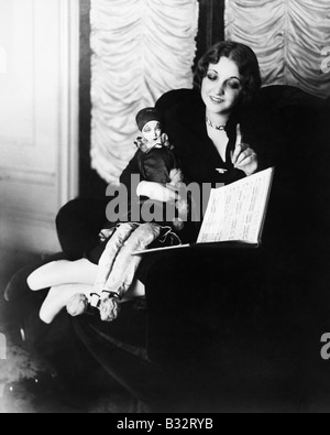 Puppet is sitting and reading Stock Photo - Alamy
