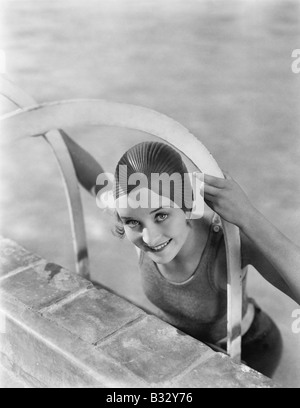 Climbing out of Swimming Pool Stock Photo - Alamy