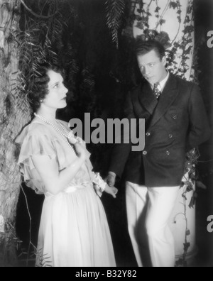 Romantic and nostalgic guy holding hands on heart with eyes closed ...