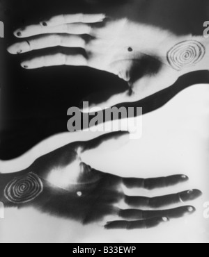 Positive and negative hands with spiral and dot tattoos positioned to ...