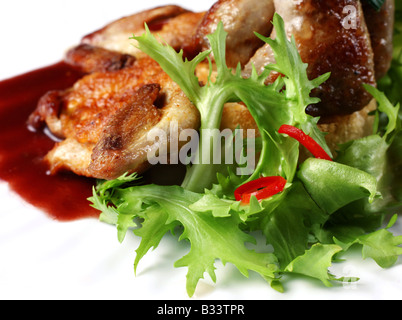 Quail fried meat wth sauce on white plate Stock Photo - Alamy