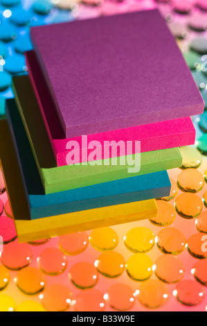 Stack of colored note pads with glass bead background Stock Photo - Alamy