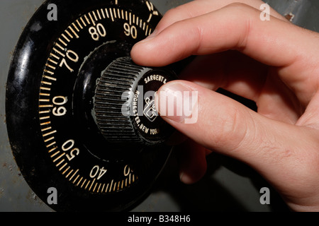 Hand turning the combination dial of a safe Stock Photo - Alamy