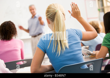 Students answering questions in math class with teacher Stock Photo - Alamy