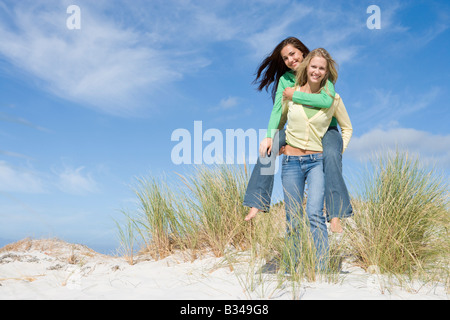 Woman giving her best a friend a piggyback ride Stock Photo - Alamy