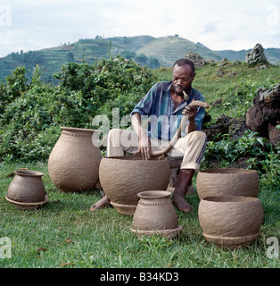 Uganda, Southwest Uganda, Muko. A potter fashions cooking pots by the ...