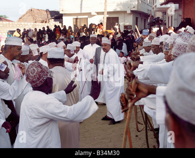 Swahili men in traditional dress celebrate MAULIDI AL NABI or Prophet s ...